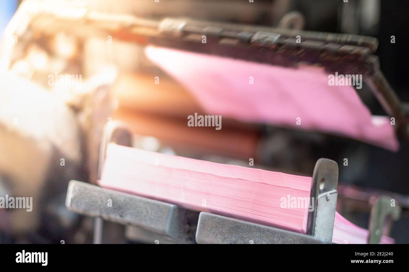 The photo effect with the printing press machine takes sheet of paper ...