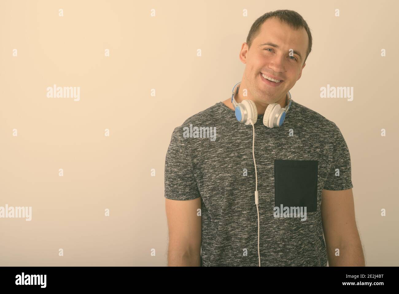 Studio shot of young happy muscular man smiling while wearing ...