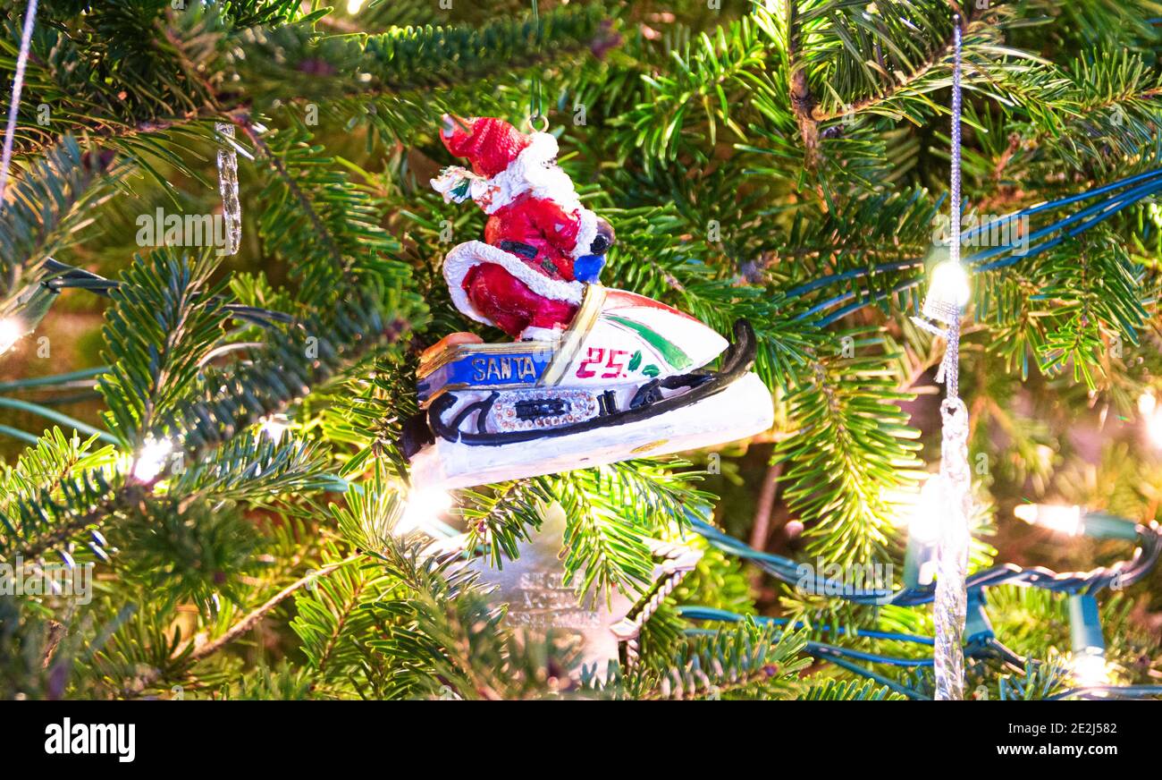 Santa claus riding a jet ski Christmas ornament hanging from a ...