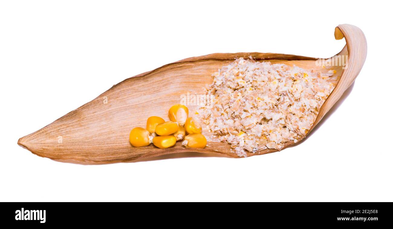 Corn bran with yellow corn kernels on a dry brown corn leaf cut on an ...
