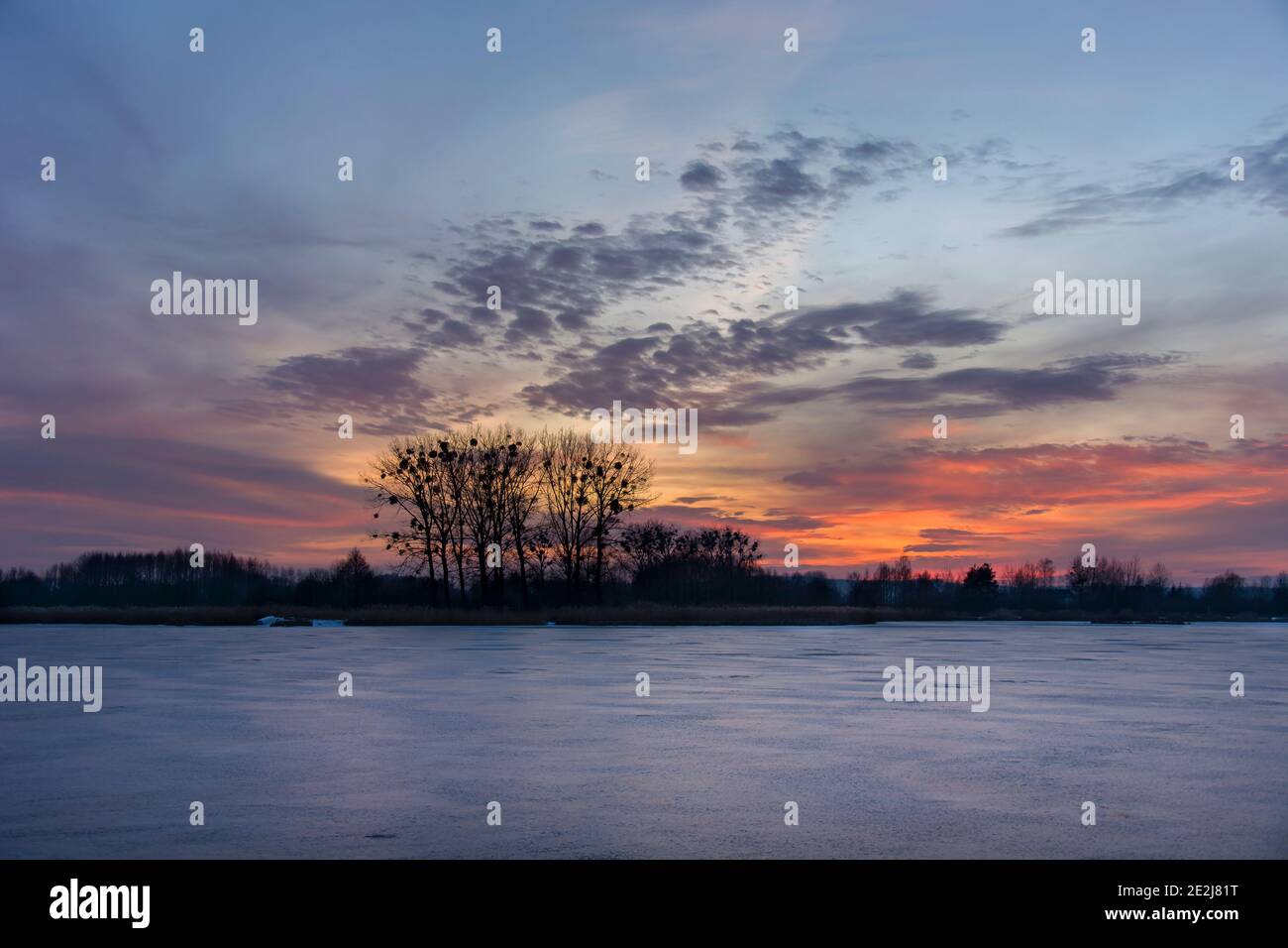 Frozen lake, trees and colorful evening sky, winter landscape Stock ...