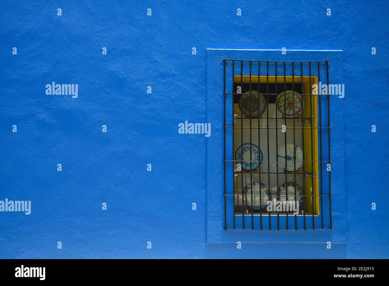 Adobe house window with Talavera plates display and handcrafted iron ...