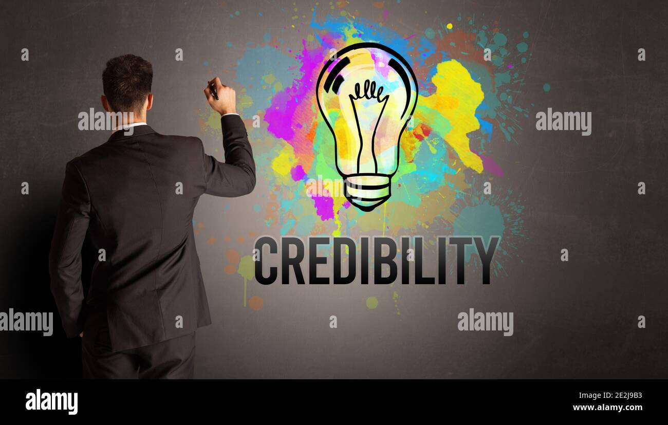 businessman drawing colorful light bulb with CREDIBILITY inscription on ...