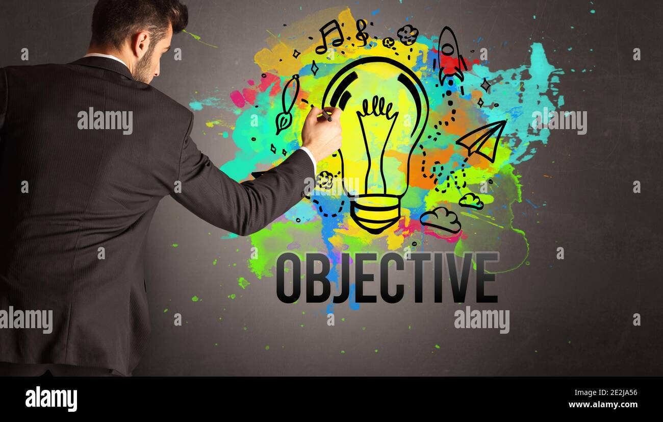 businessman drawing colorful light bulb with OBJECTIVE inscription on ...