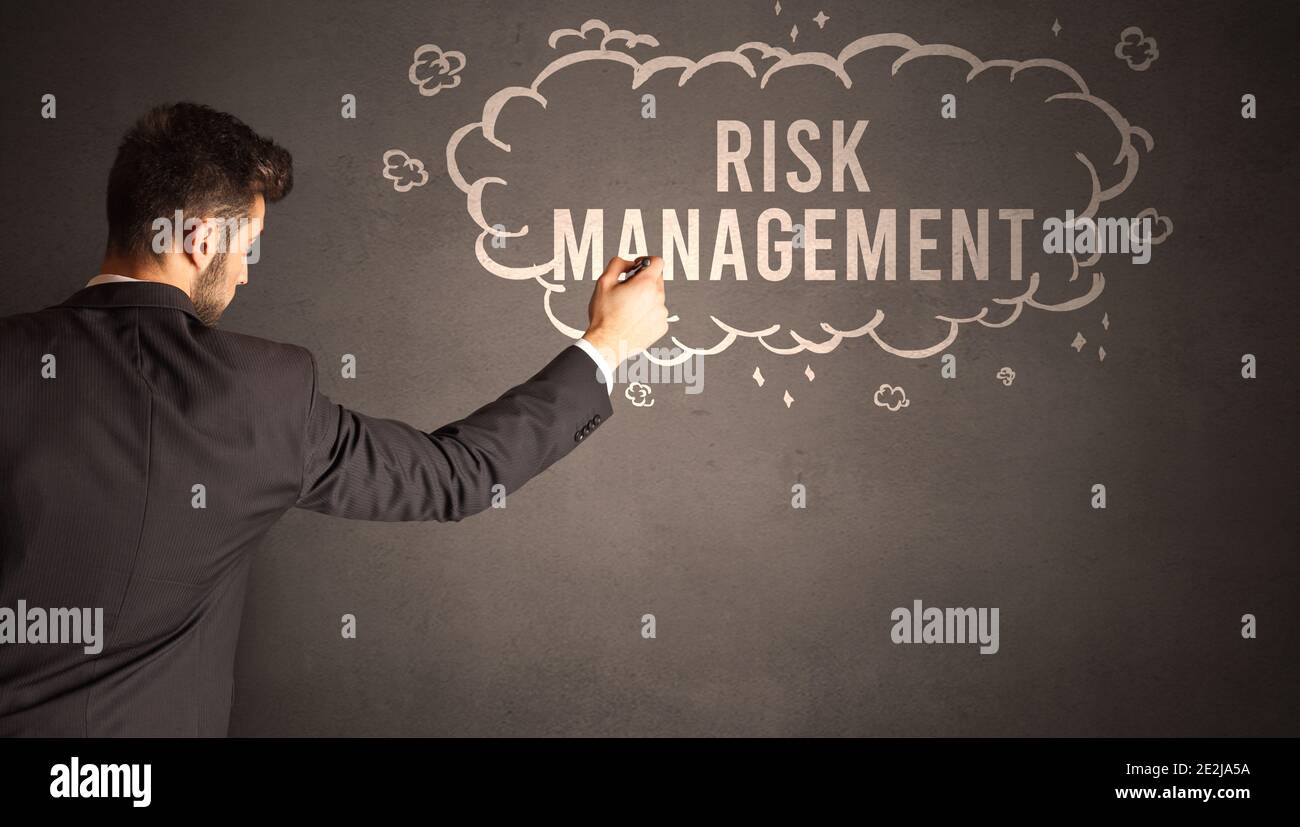 businessman drawing a cloud with RISK MANAGEMENT inscription inside ...
