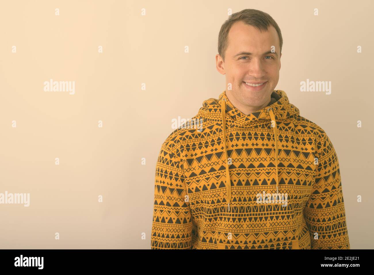 Studio shot of young happy muscular man smiling against white ...