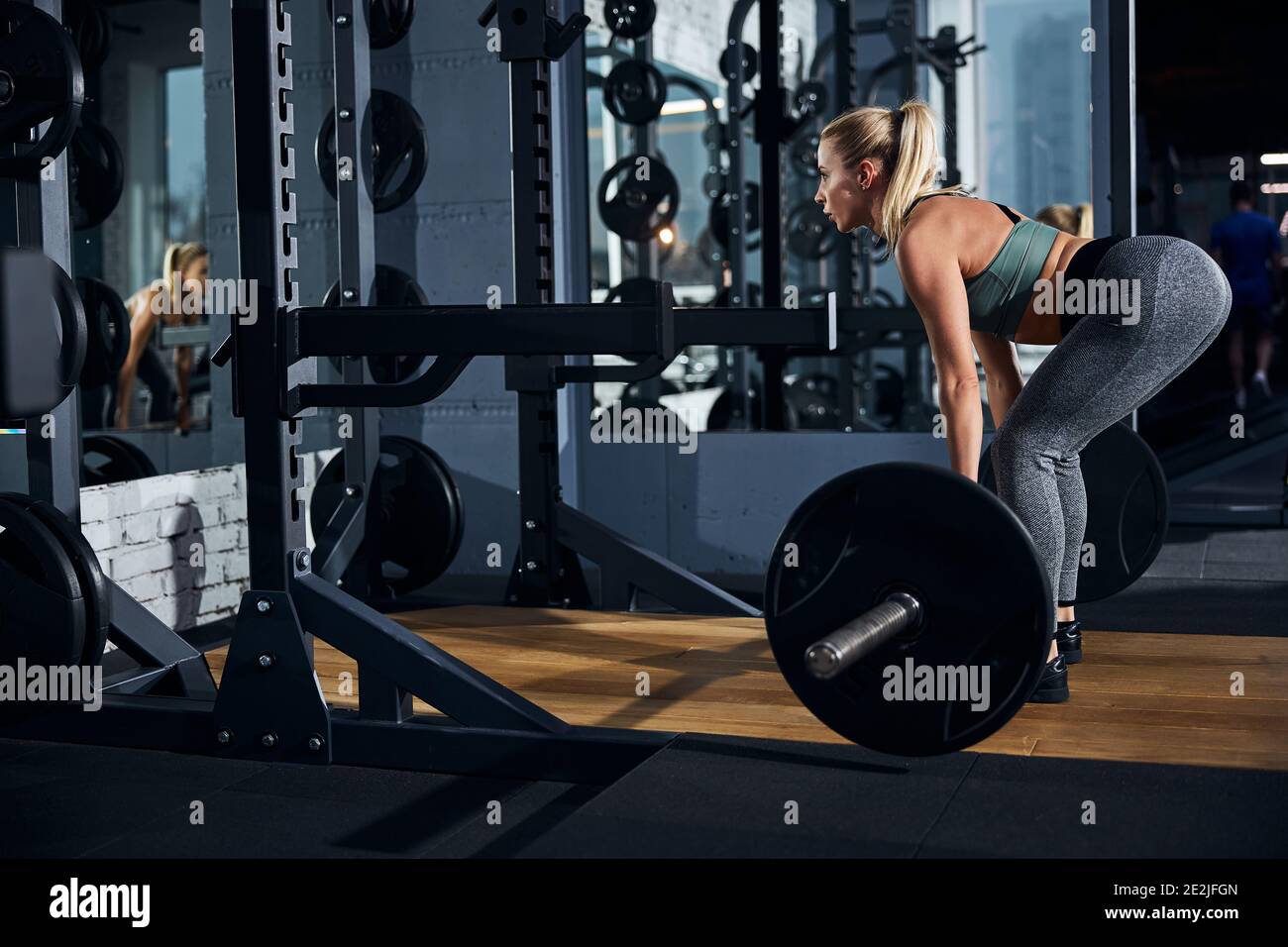 Sports lady pulling weight off the floor Stock Photo - Alamy
