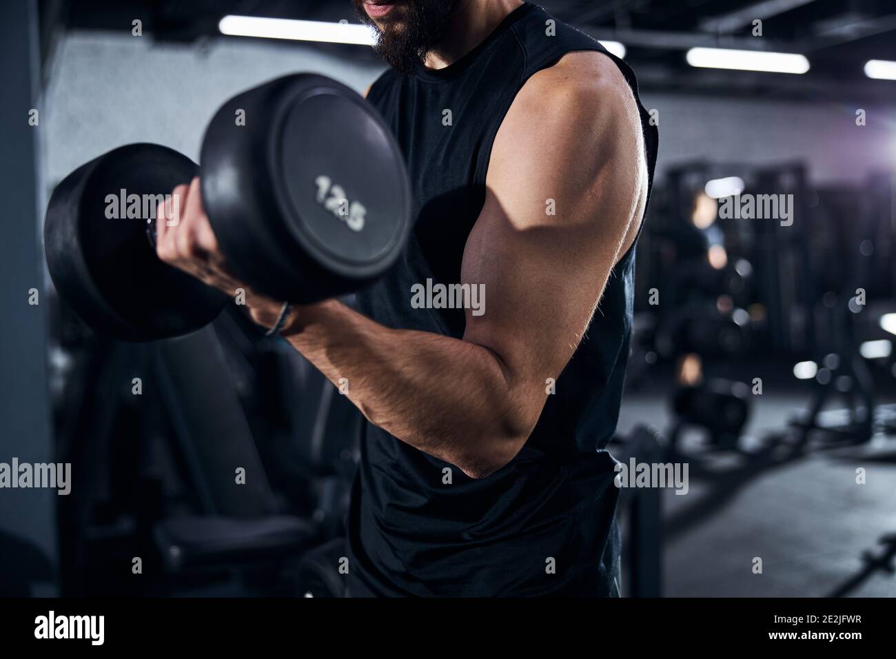Strong male arm lifting a hand weight Stock Photo - Alamy