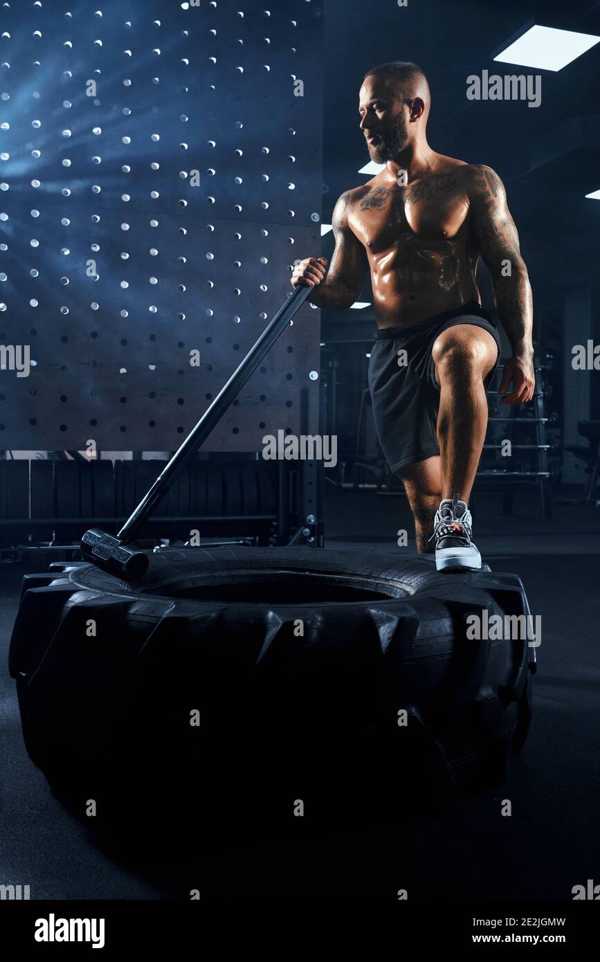 From above view of muscular caucasian man carrying big sledgehammer in ...