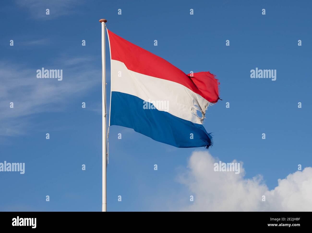 Low angle shot of the flag of the Netherlands under the cloudy sky ...