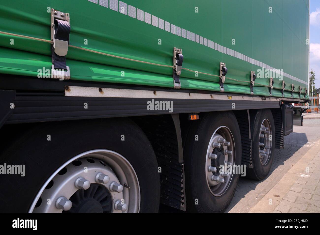 Transport and unloading. Semi-trailer with covered tarpaulin before ...