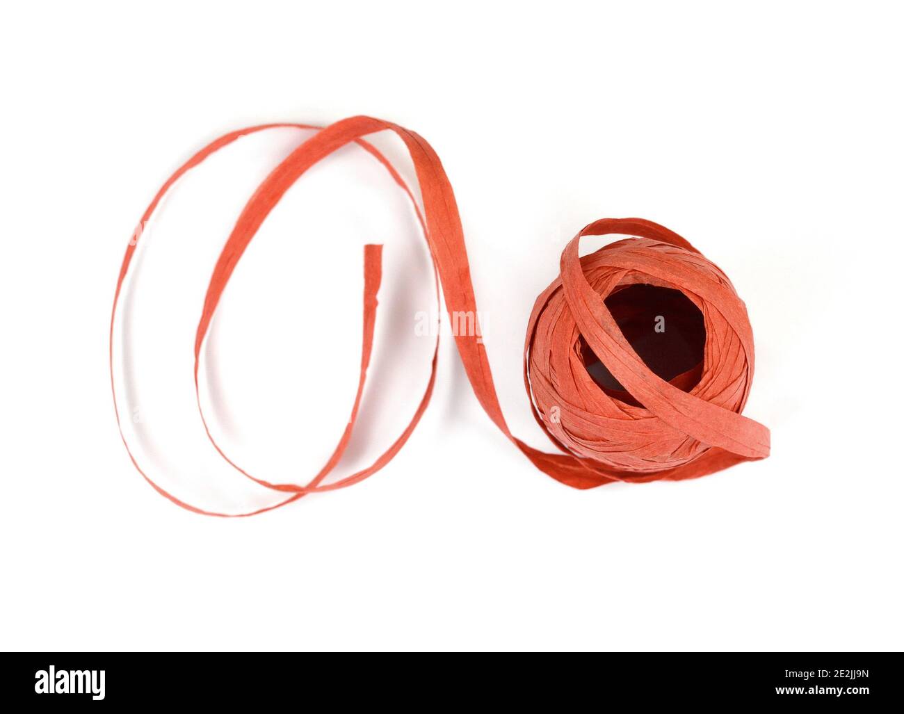Paper Red ribbon roll isolated on white background Stock Photo - Alamy