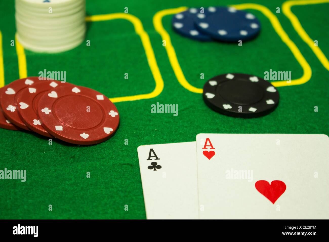 Two cards - a black clubs ace and a red hearts ace - with diverse ...