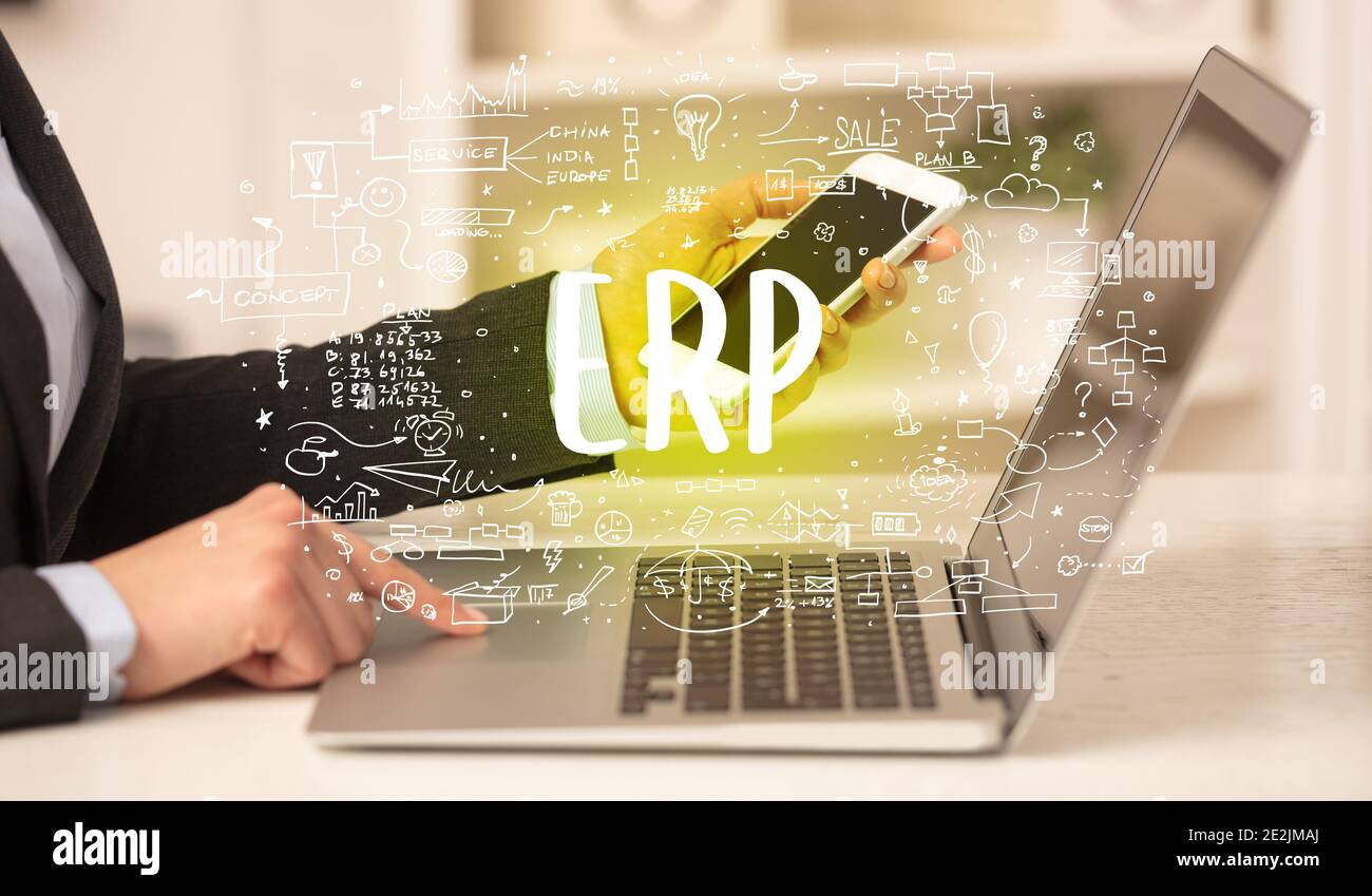 hand working on new modern computer with ERP abbreviation, modern ...