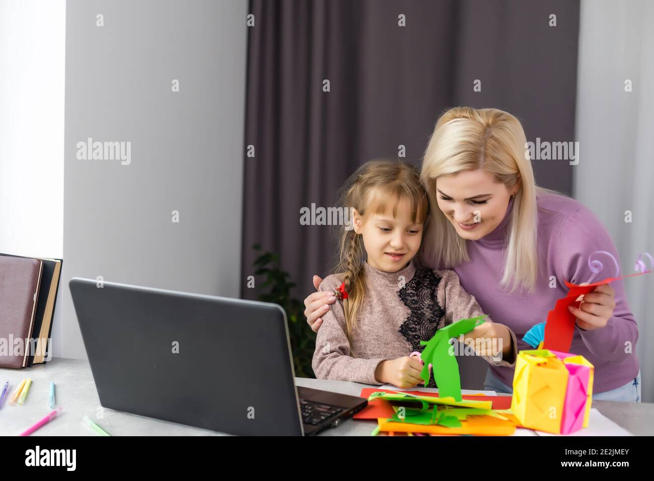mother and daughter make paper crafts together Stock Photo - Alamy
