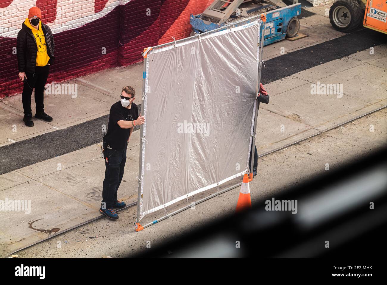 The grip and electric crew working on set of a film production in ...