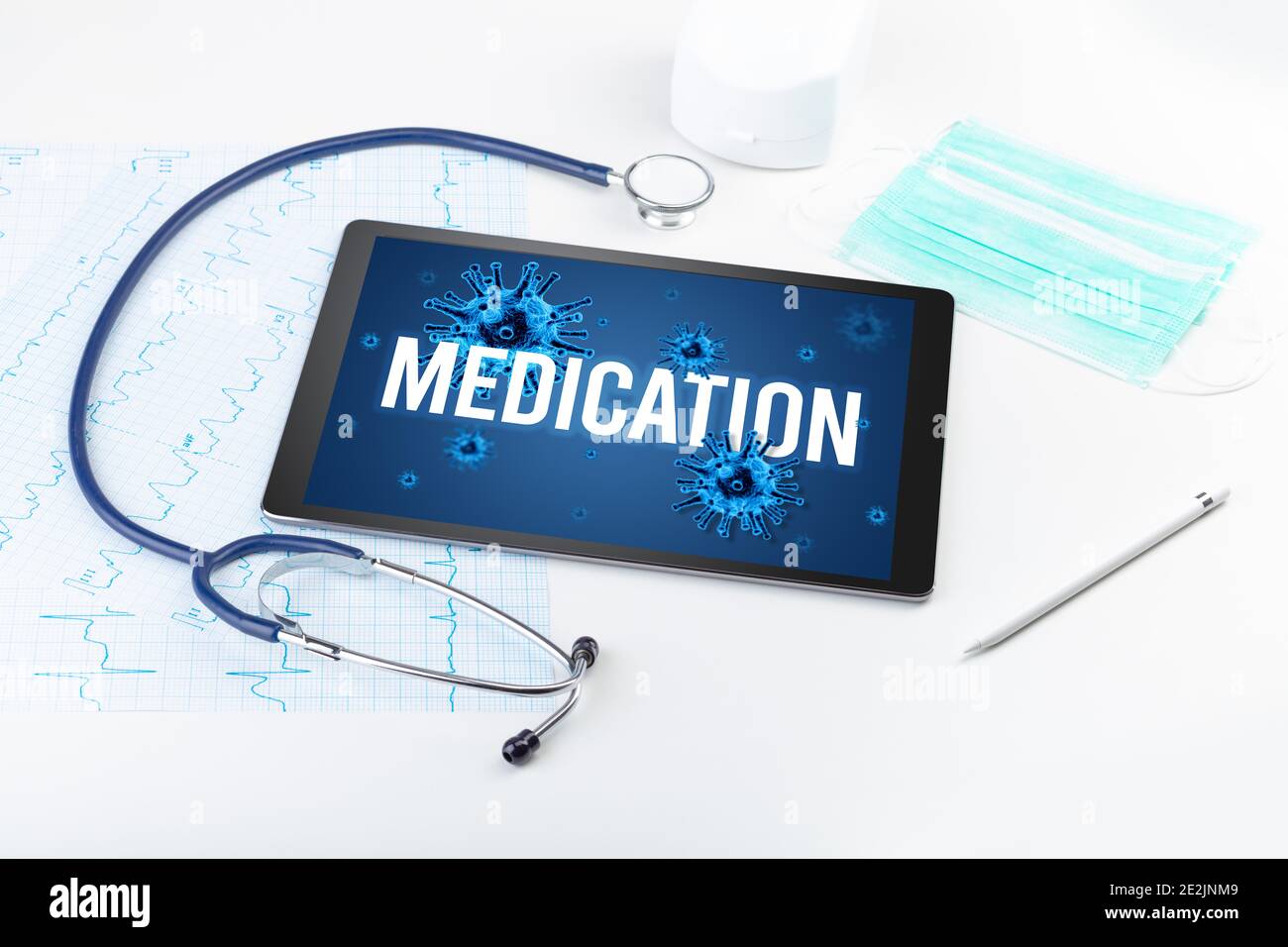 Tablet pc and doctor tools on white surface with MEDICATION inscription ...