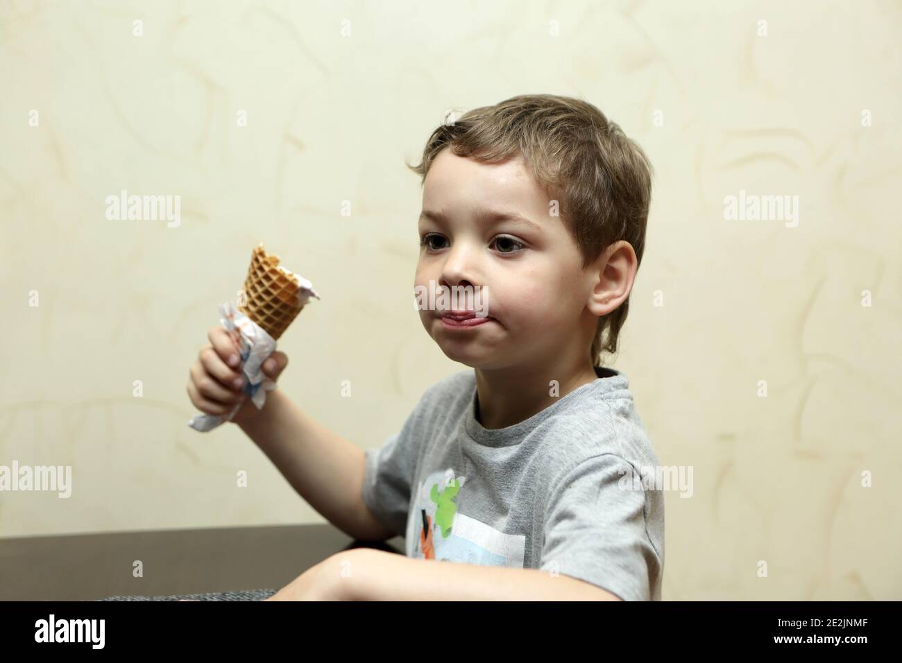 Child eating ice cream cone in cafe Stock Photo - Alamy