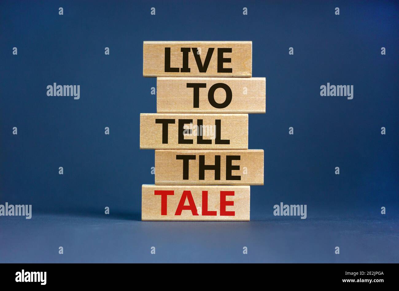 Live to tell the tale symbol. Wooden blocks with words 'live to tell ...