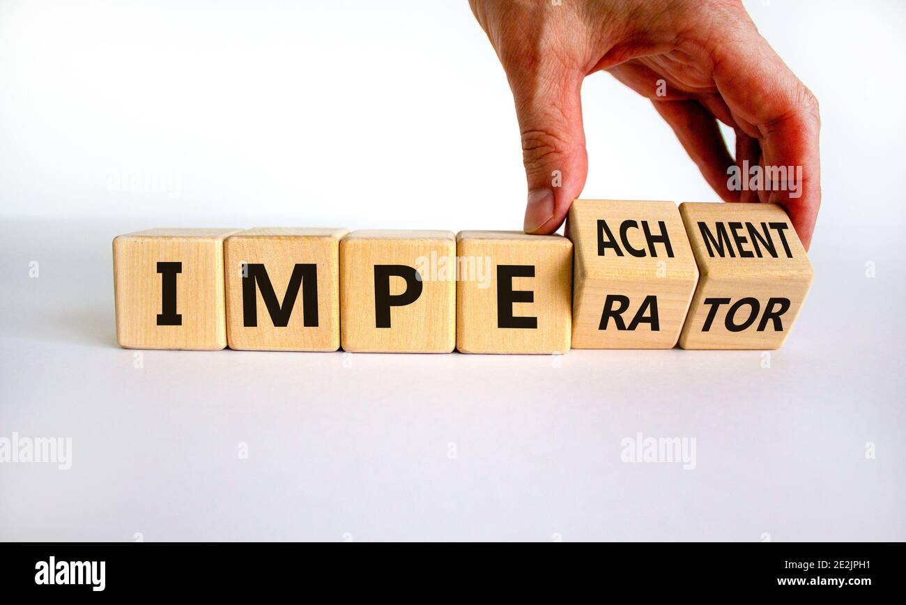 Imperator or impeachment symbol. Businessman hand turns wooden cubes ...