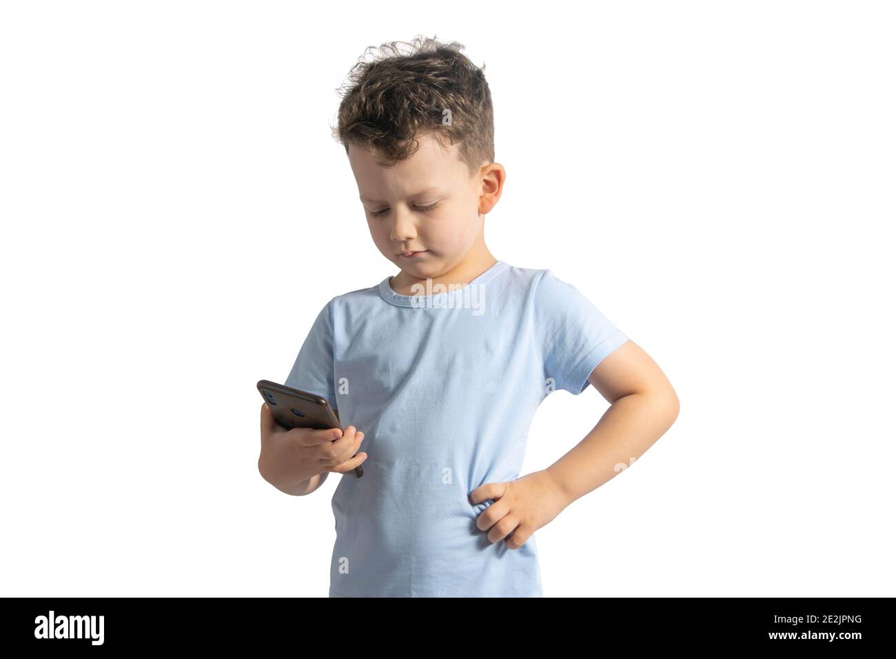 A cute little boy communicates on a cell phone. The concept of modern ...
