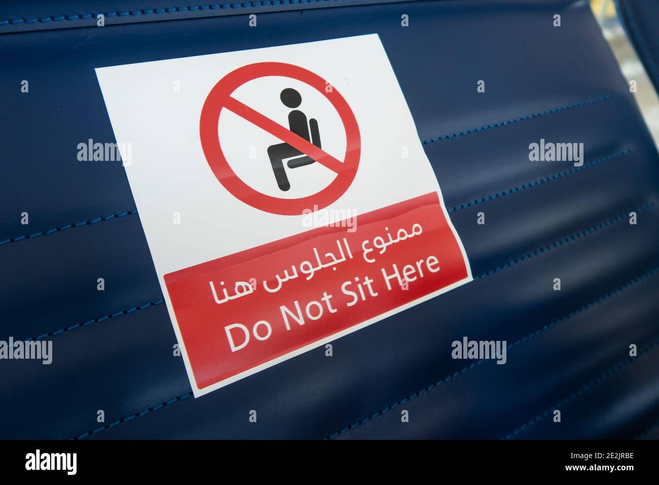 Sticker sign 'Do not sit here' in english and arabic on a seat at the ...