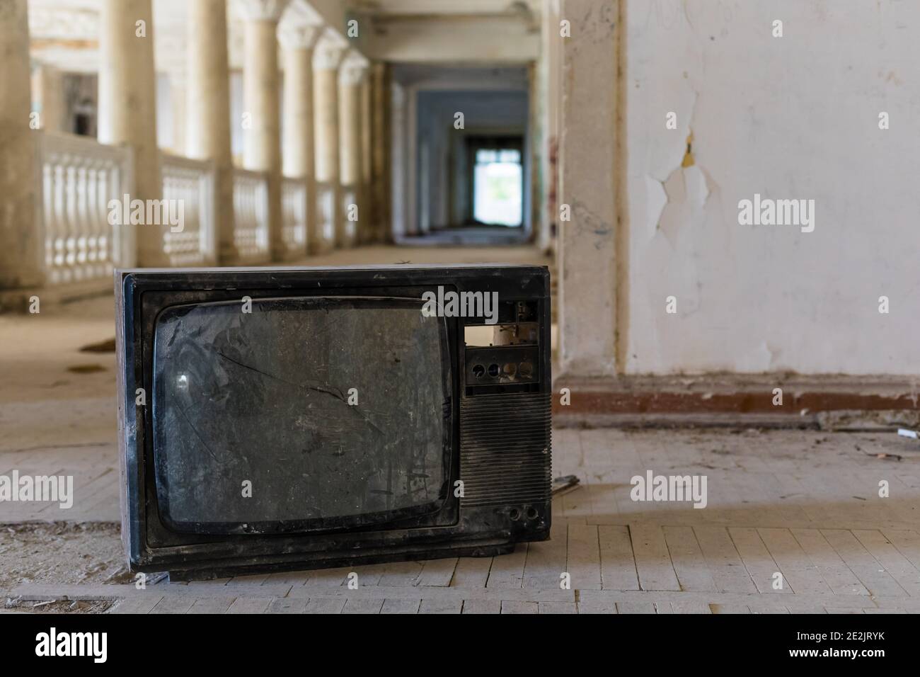 Broken dusty television set in the interior of abandoned building of ...