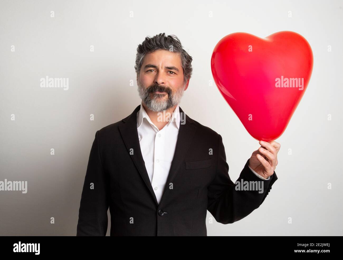 Love and valentines day man holding heart smiling cute and adorable ...