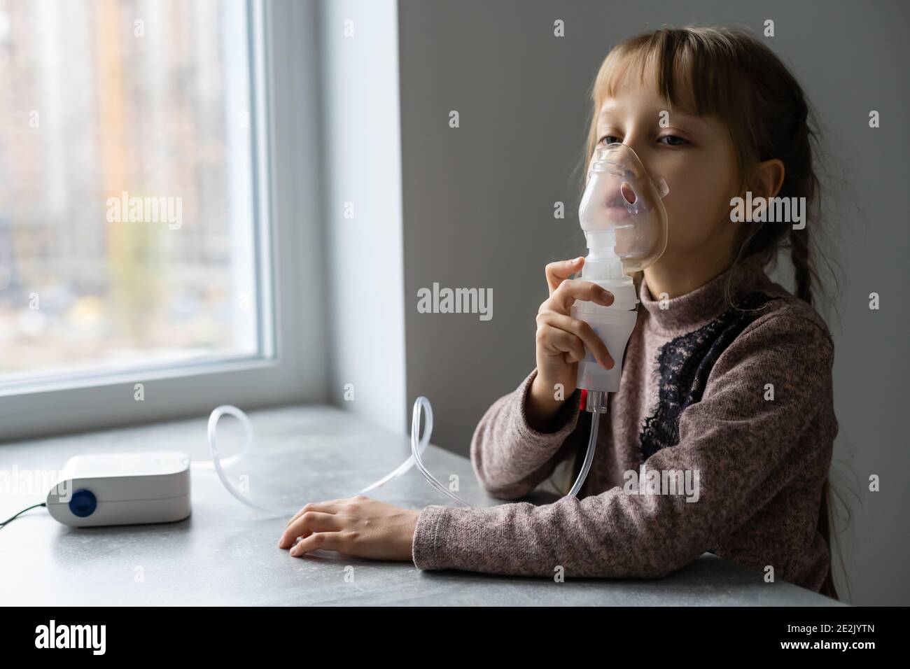 Little girl making inhalation with nebulizer at home. child asthma ...