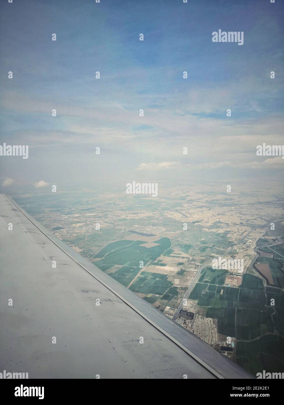 Vertical shot of an airplane wing and the natural landscape Stock Photo ...