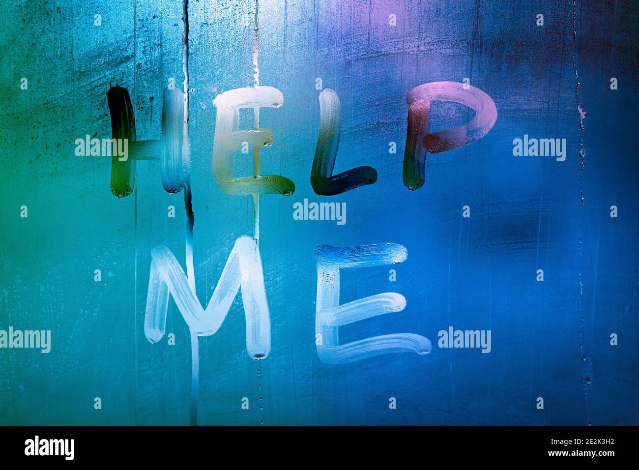 words help me handwritten on night wet window glass with green and blue ...