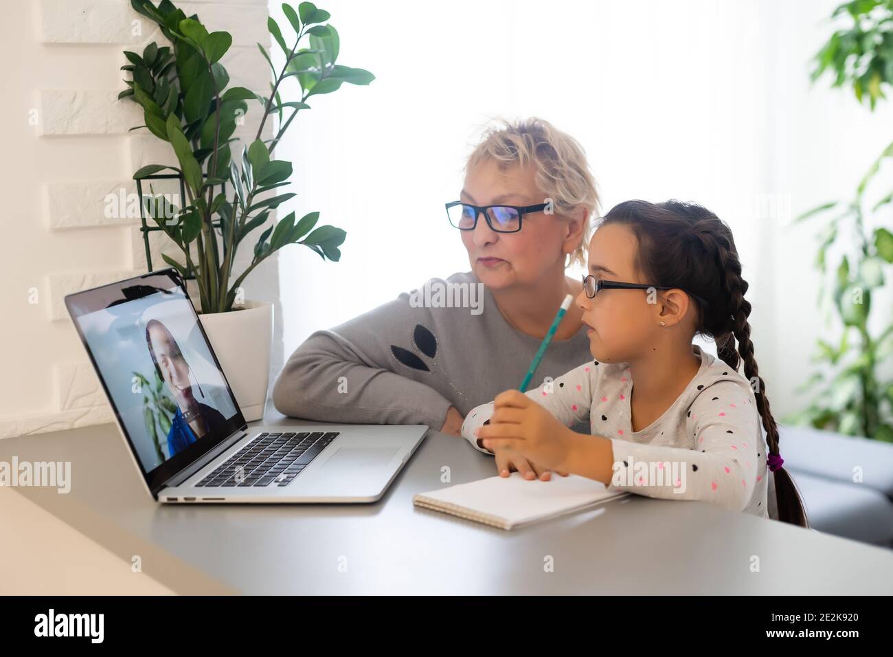 Helpful granny. Helpful loving granny assisting her cute granddaughter ...