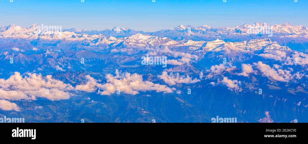 Aerial panoramic banner view of the Swiss Alps with green valley and ...