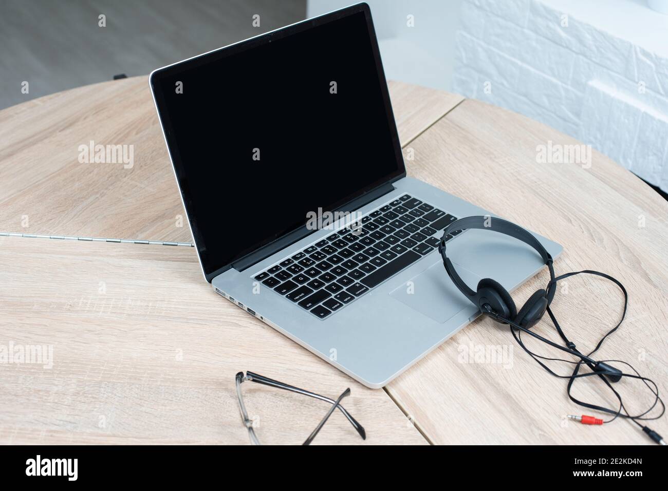 online conversation using laptop and headphones at office desk Stock ...