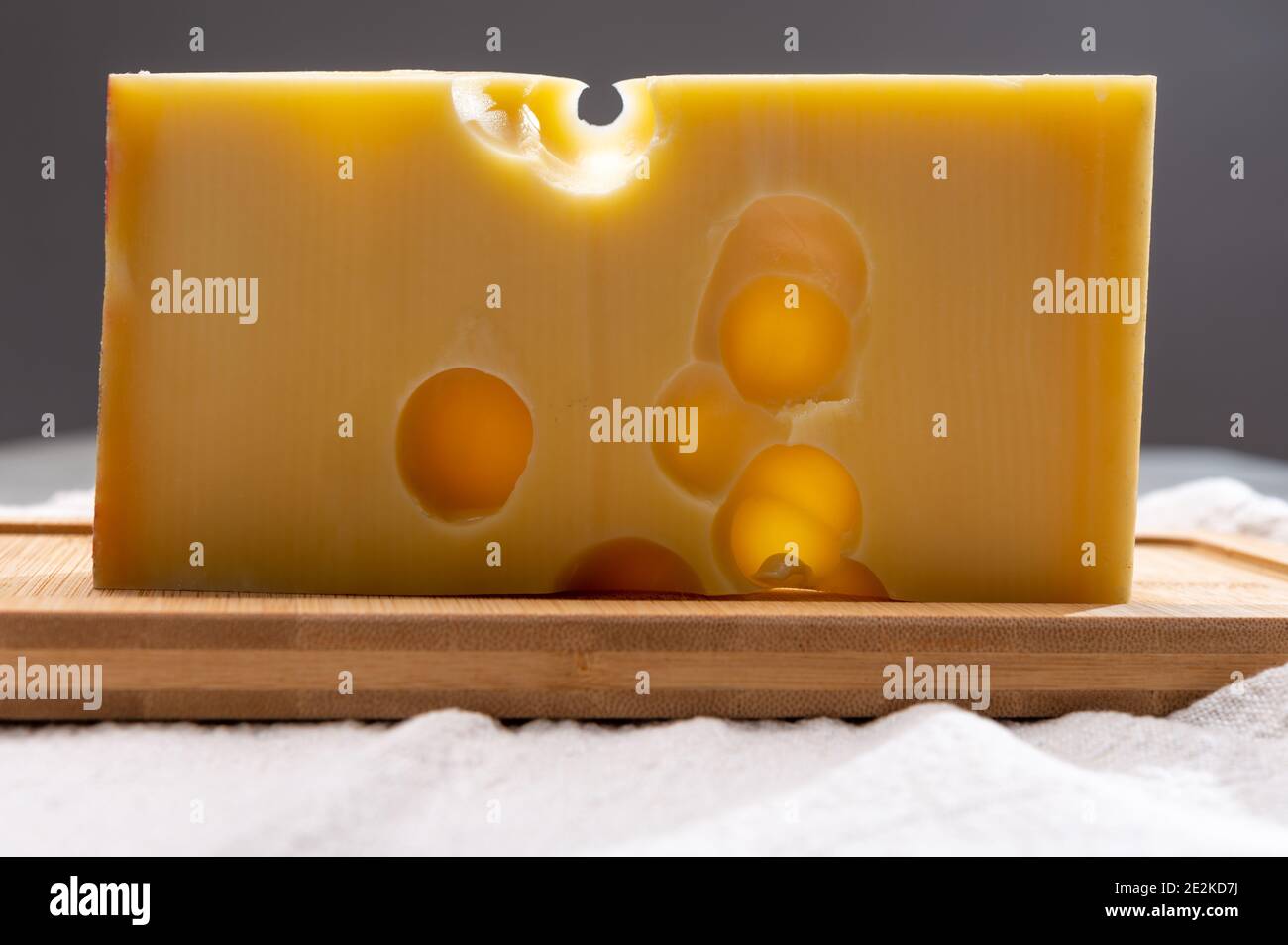 Block of Swiss medium-hard yellow cheese emmental or emmentaler with ...