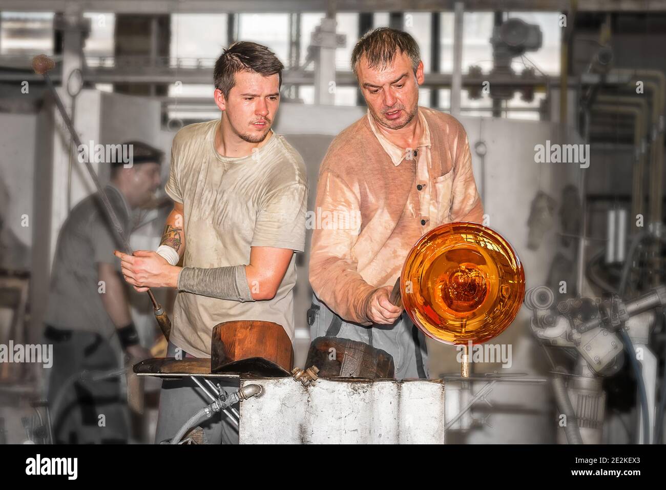 Transforming a hot mass of glass drawn from a hot oven into a work of ...