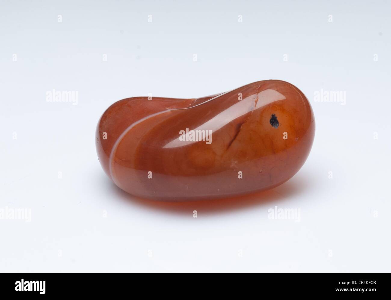 Natural stone carnelian on a white background Stock Photo - Alamy