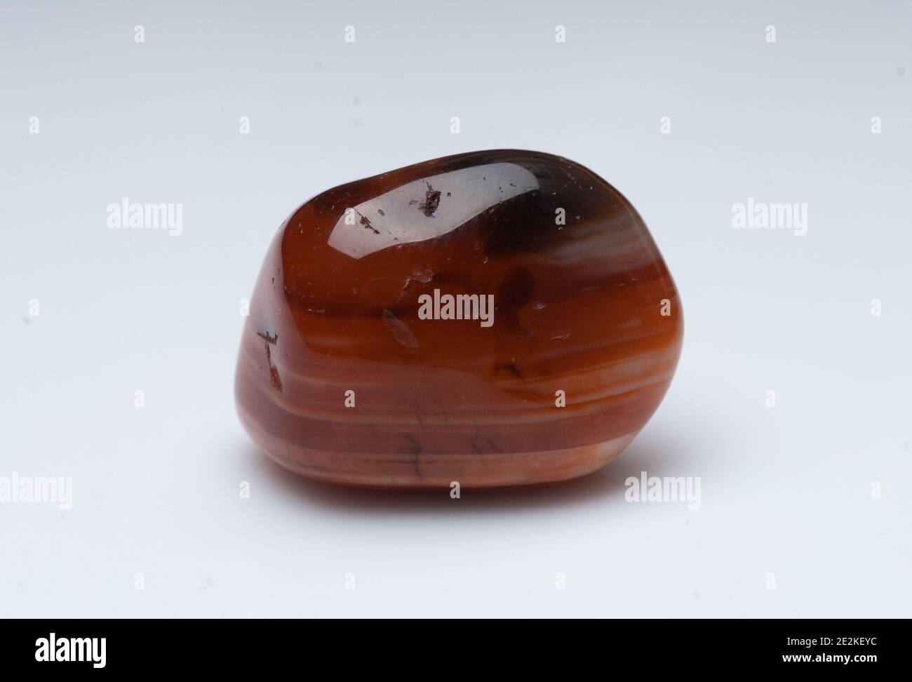 Natural stone carnelian on a white background Stock Photo - Alamy
