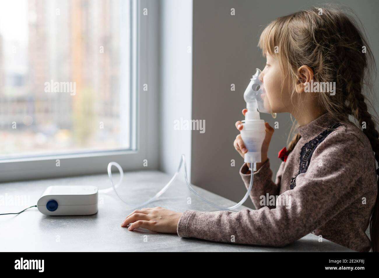 Little girl making inhalation with nebulizer at home. child asthma ...
