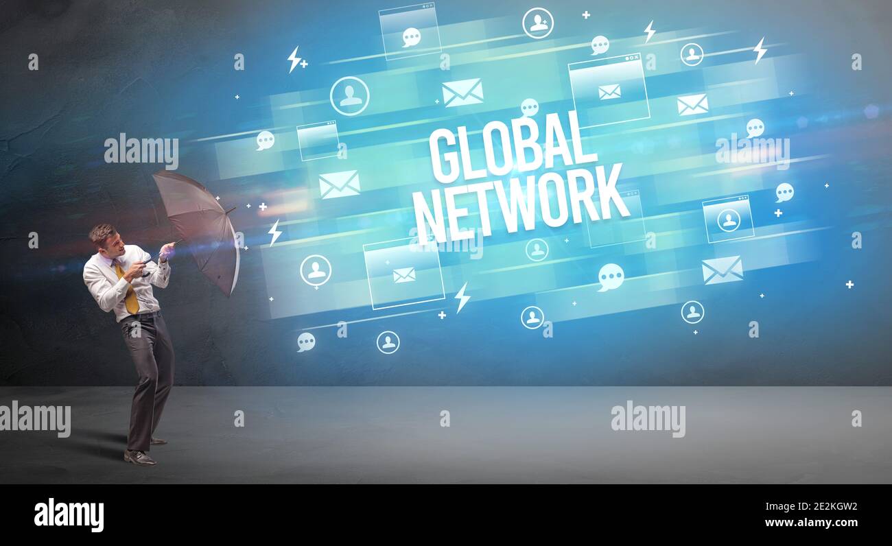 Handsome businessman defending with umbrella from GLOBAL NETWORK ...