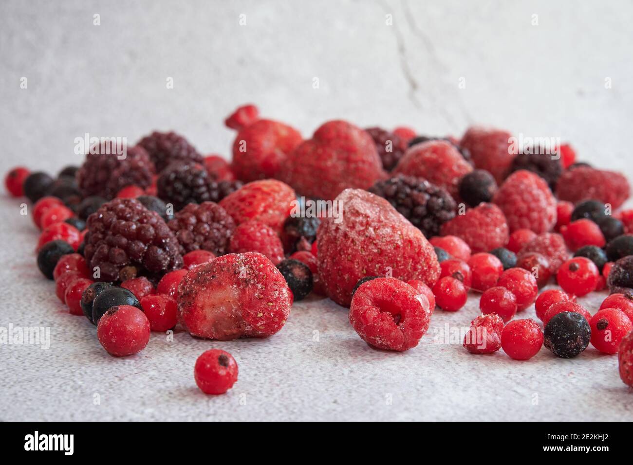 red berries scattered on a white background Stock Photo - Alamy