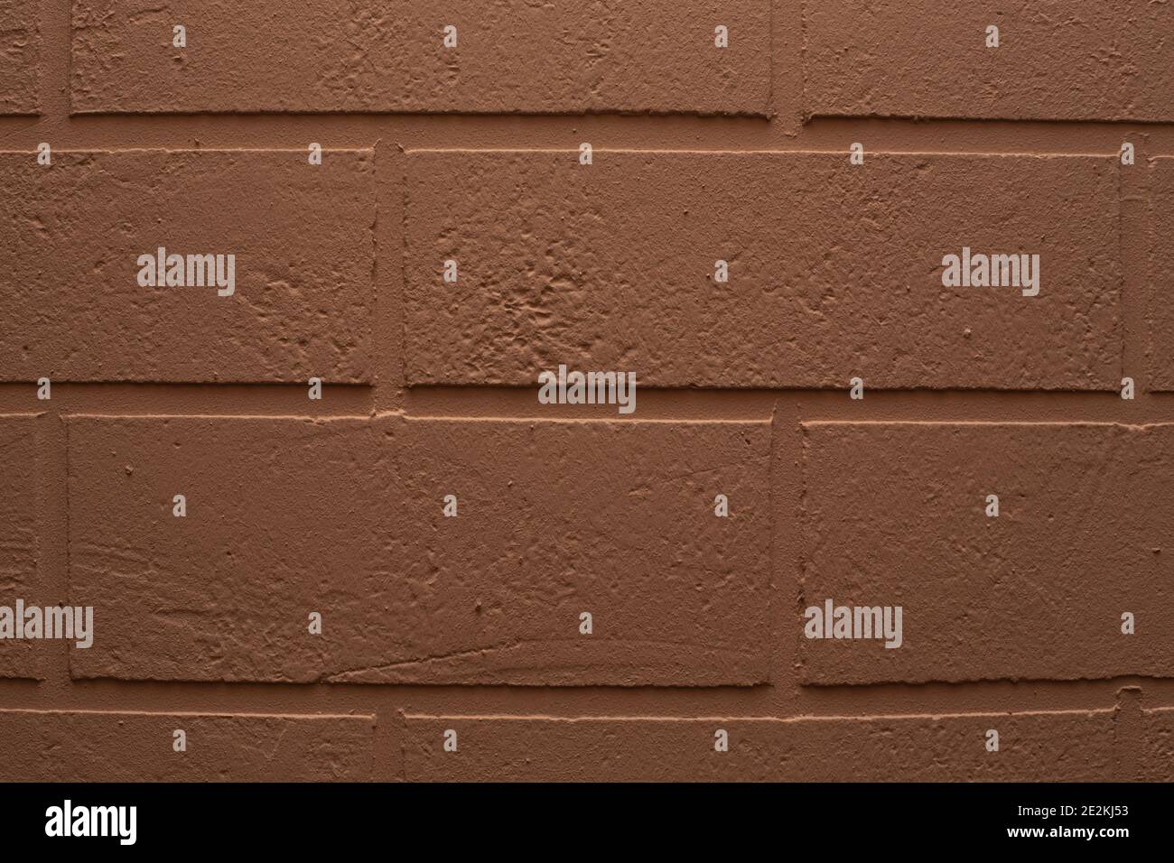 Brick wall. Decorative plaster in the form of a brick, painted brown ...