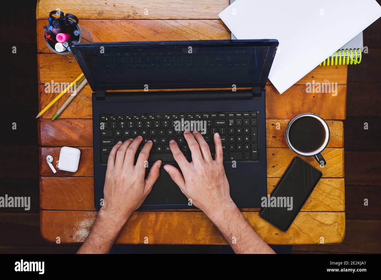 Top view of desktop and caucasian male hands working on laptop with ...