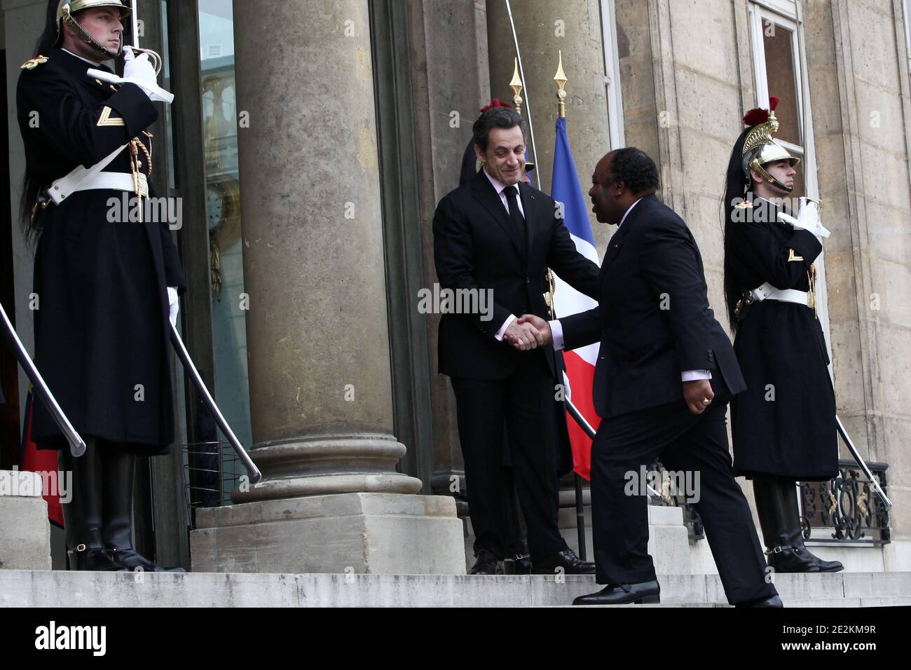 French president Nicolas Sarkozy shakes hand with his Gabonese ...