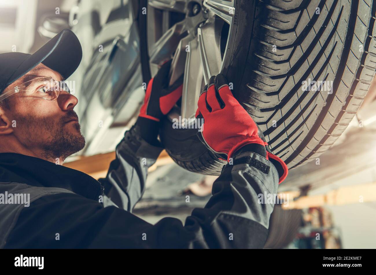 Caucasian Professional Auto Service Worker in His 30s Replacing Car ...