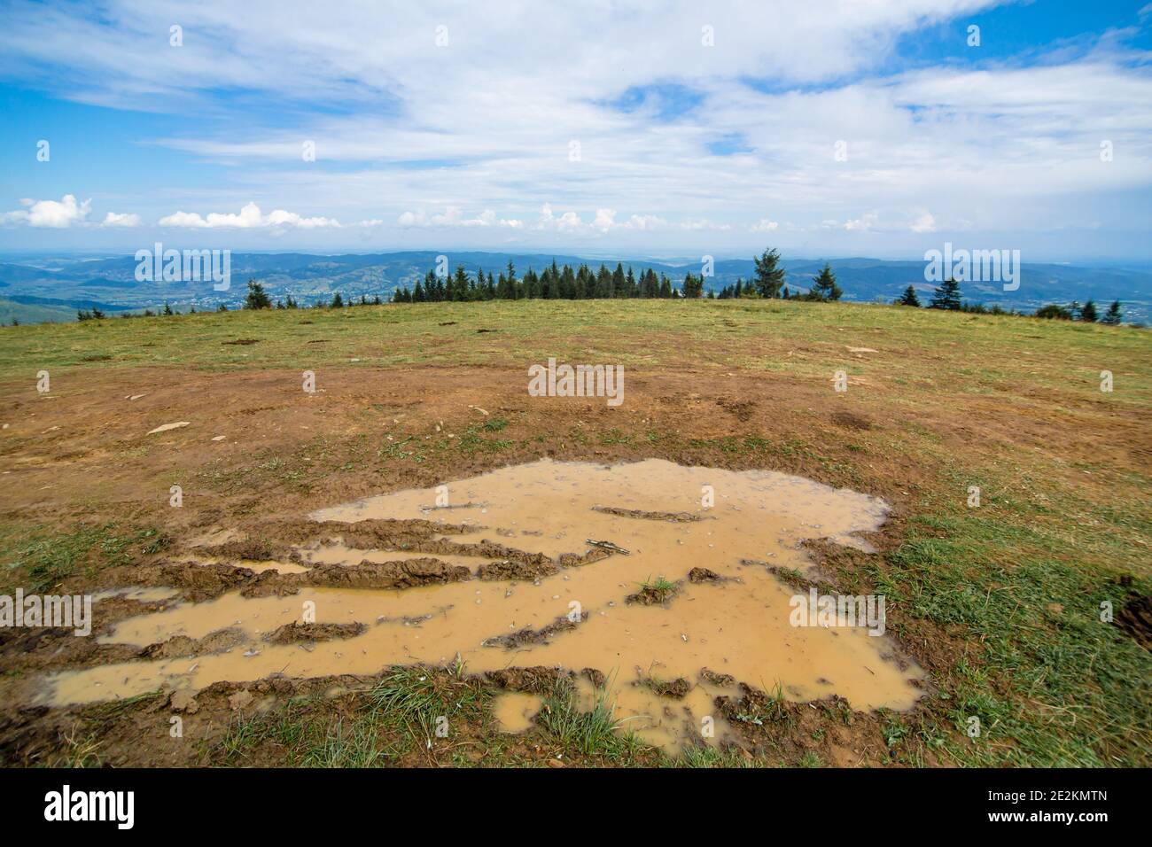 Puddle of mud on the hill top after rainy day. Nature highlands ...