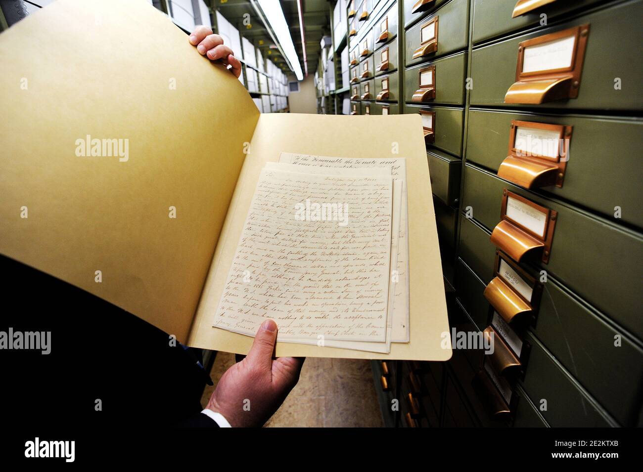 An Employee of the National Archives shows old documents stored in the ...