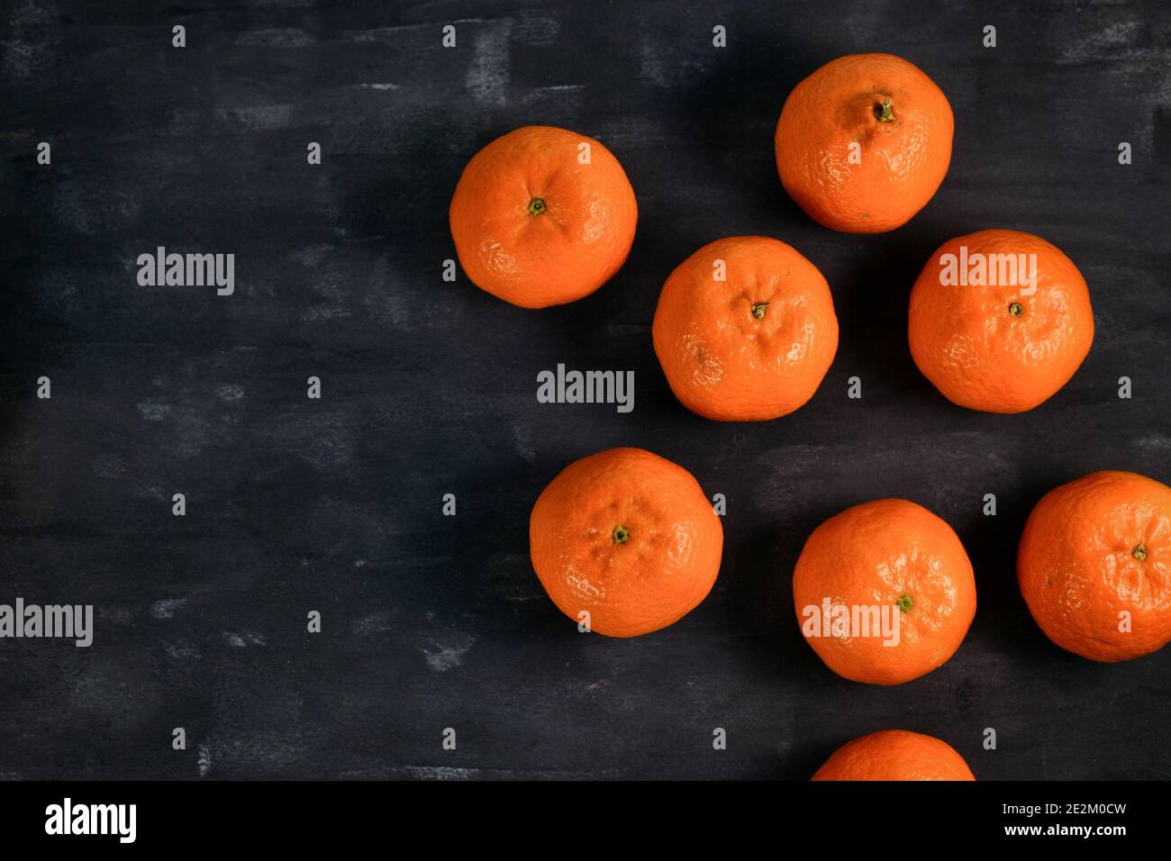 Whole mandarin fruits on dark background Stock Photo - Alamy