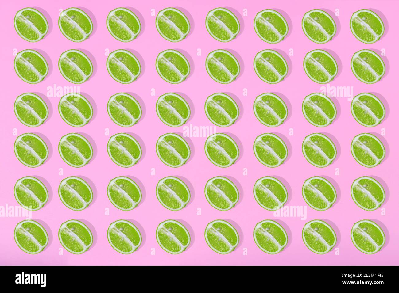 Trendy summer pattern with half of green lime on bright light pink ...