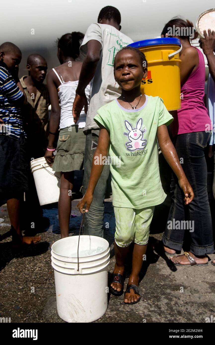Haitians receive water in Champ de Mars in Port-au-Prince, Haiti on ...